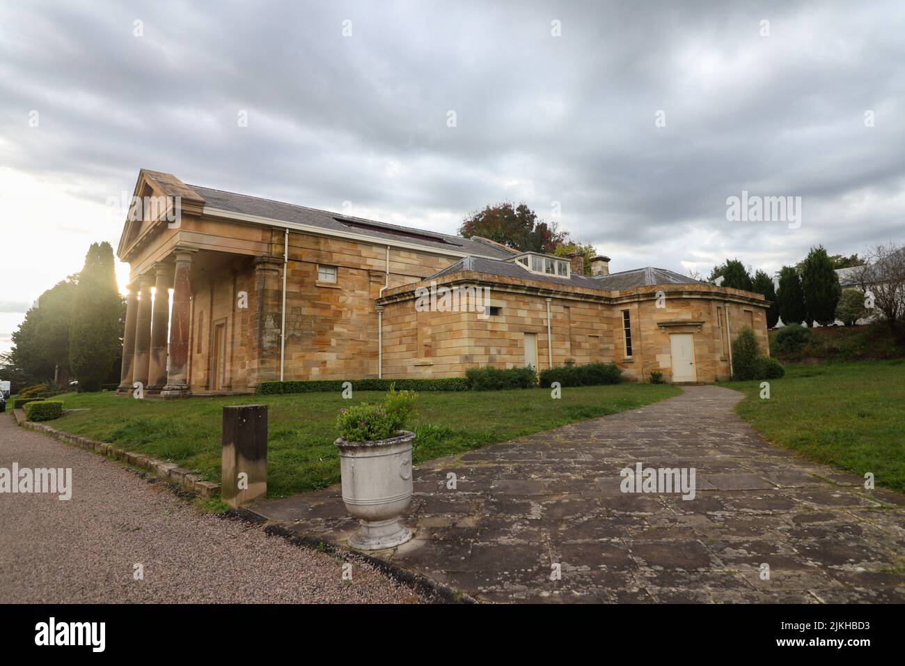 A historic Heritage building of sandstone surrounded by grasses Stock ...