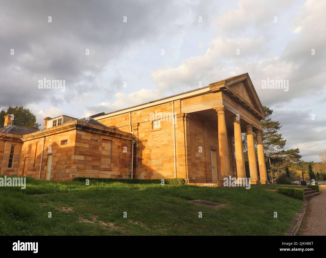 A historic Heritage building of sandstone surrounded by grasses Stock ...