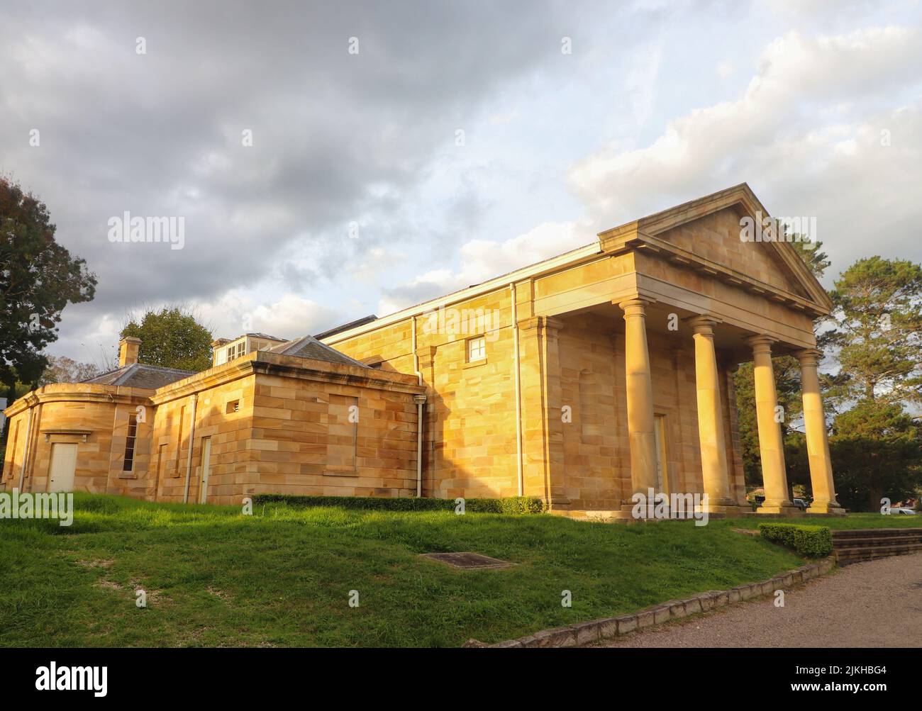 A historic Heritage building of sandstone surrounded by grasses Stock ...