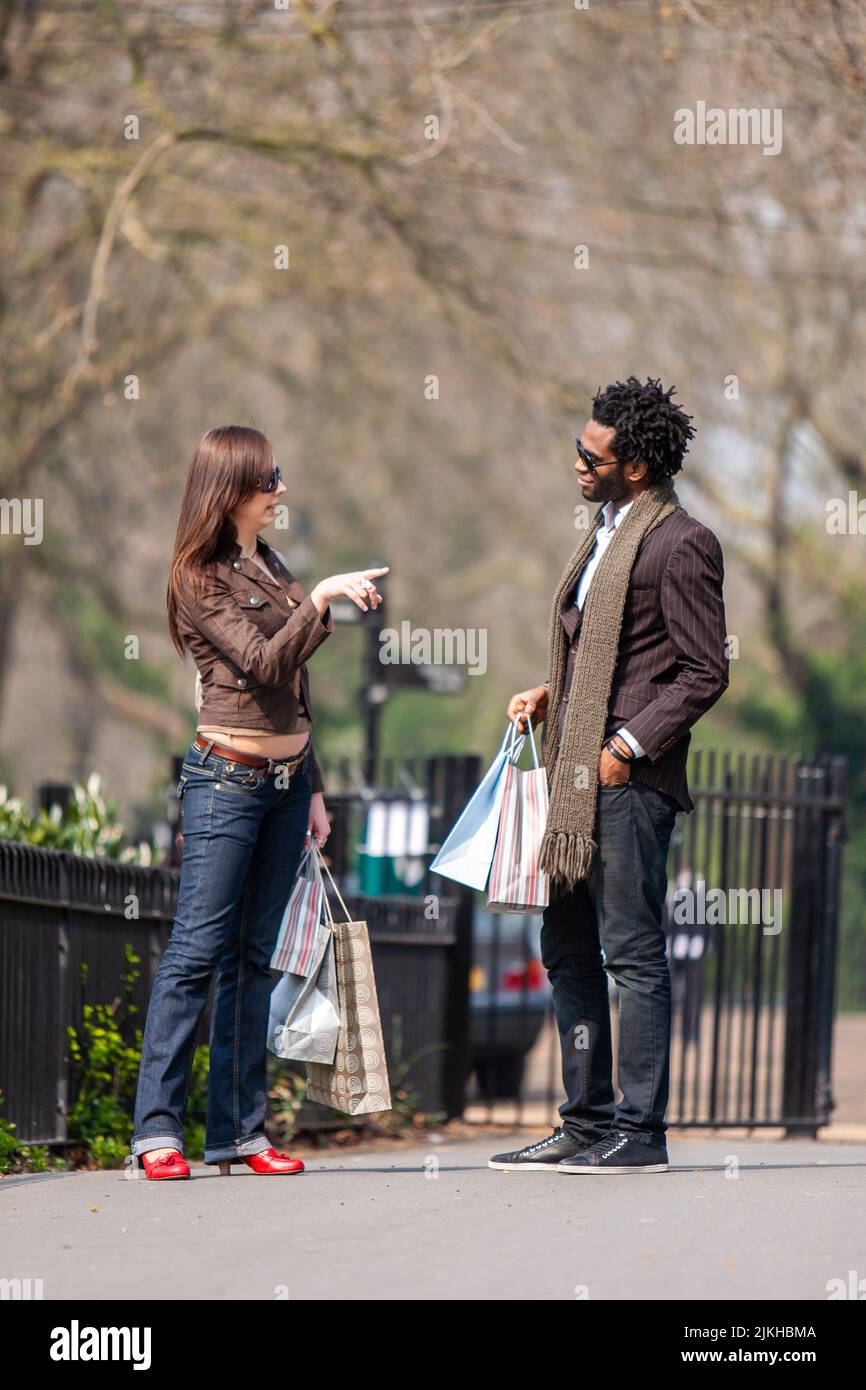 Male female chatting shopping bags hi-res stock photography and images ...
