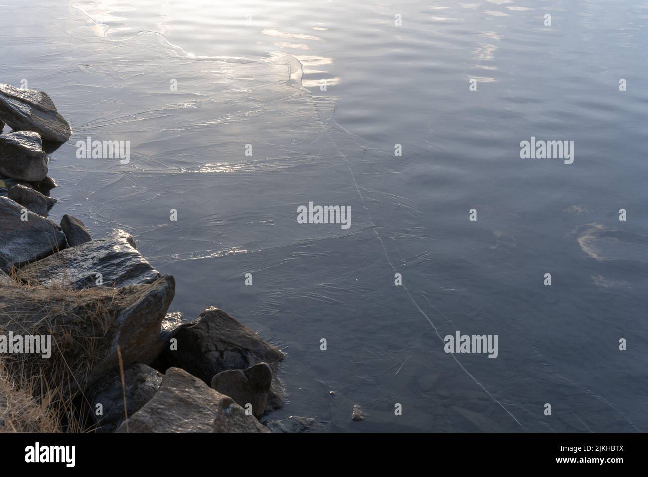 A calm clear water in the river near the big rocks Stock Photo - Alamy