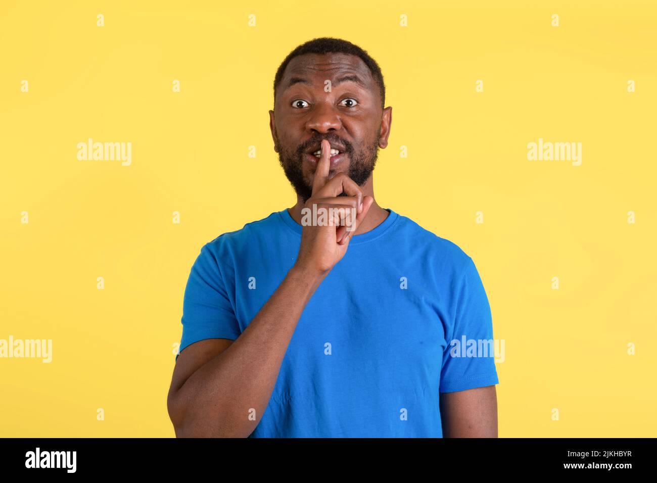 African American Man Gesturing Hush Sign Posing Over Yellow Background ...