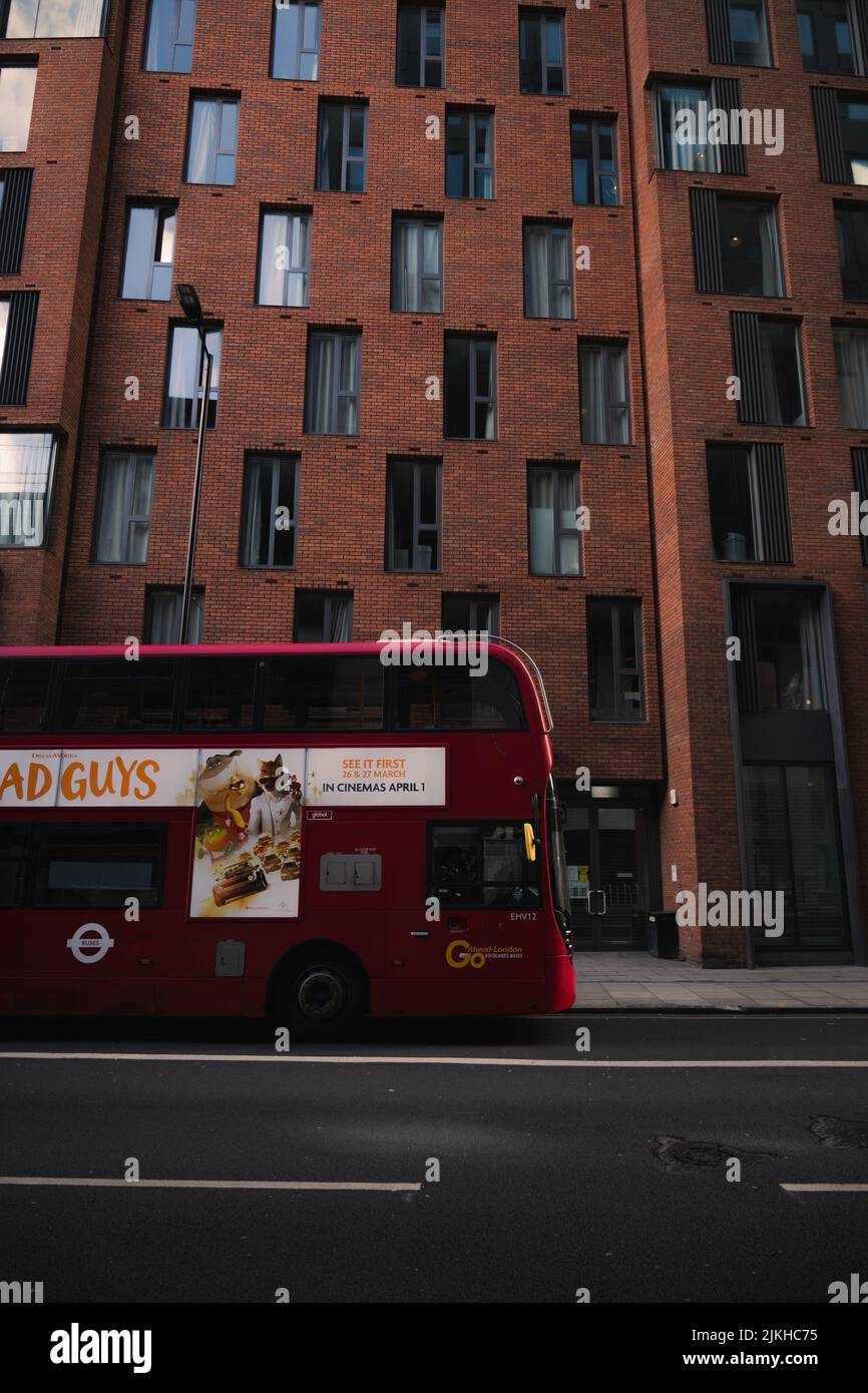 A vertical shot of a red bus in the streets of London Stock Photo - Alamy