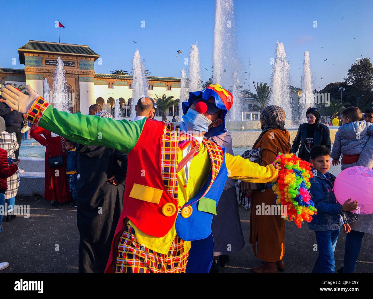 A clone sharing his smile under a medical mask surrounded by people on ...