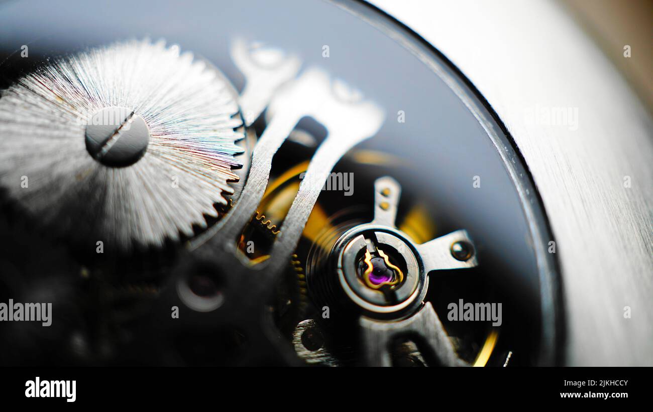 A closeup of gears and other mechanisms inside a pocketwatch Stock ...