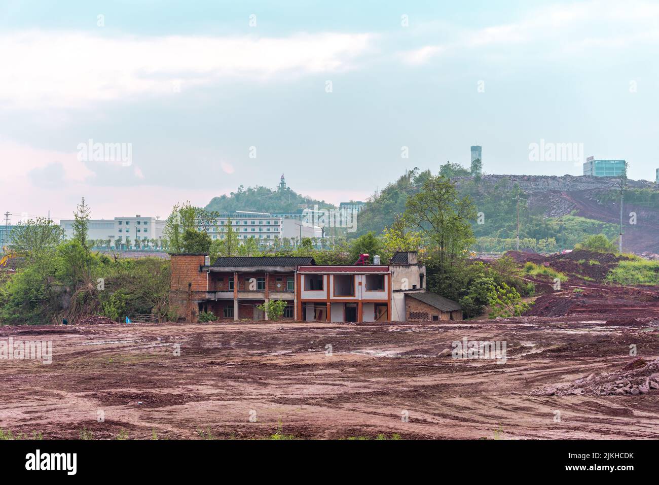 An old buildings in front of the construction of a tumble-down land ...