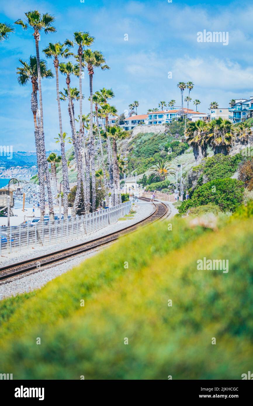 A vertical shot of a railroad stretching through the coastline with ...