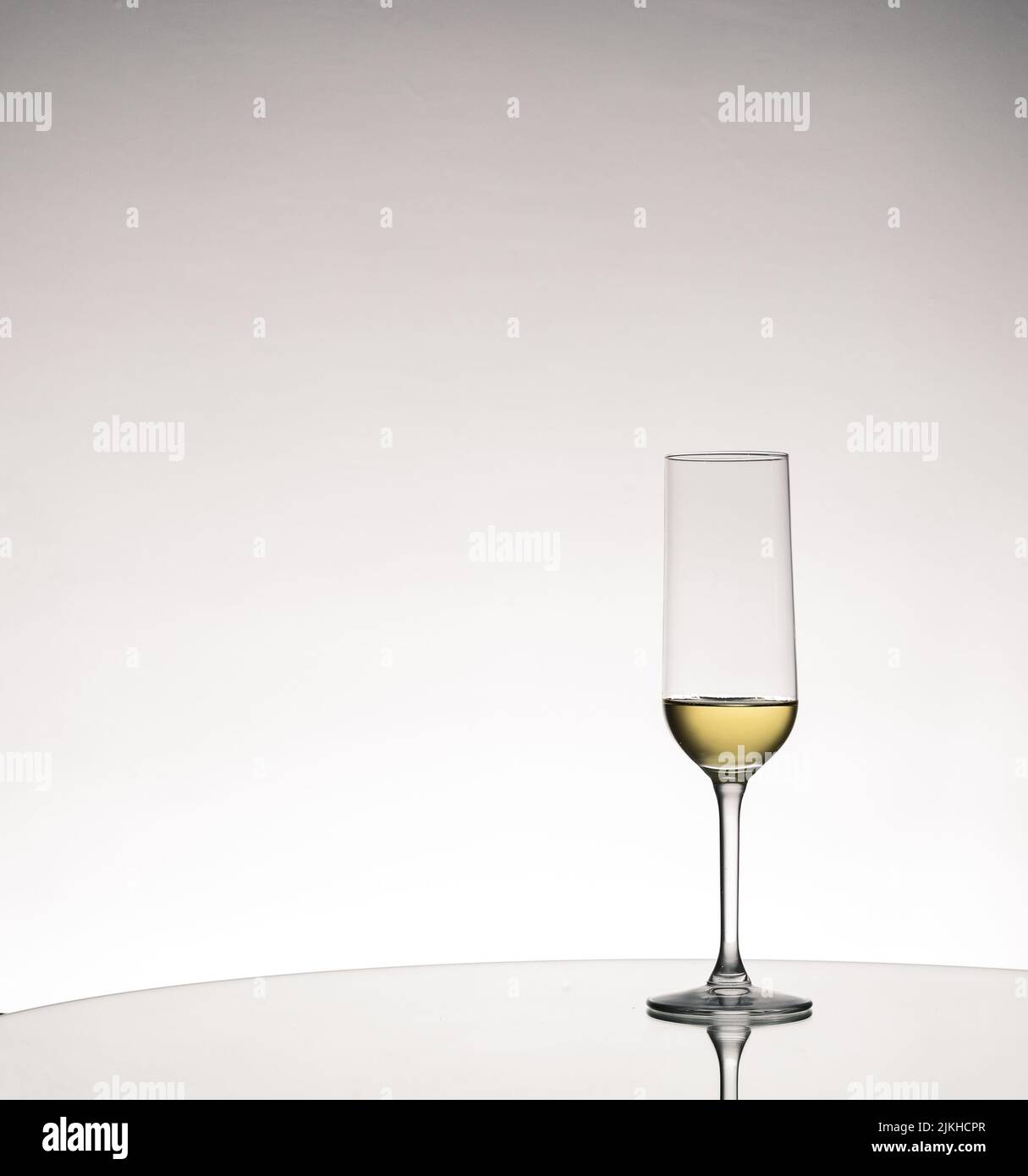 A glass cup of wine with reflection on a mirror surface Stock Photo - Alamy