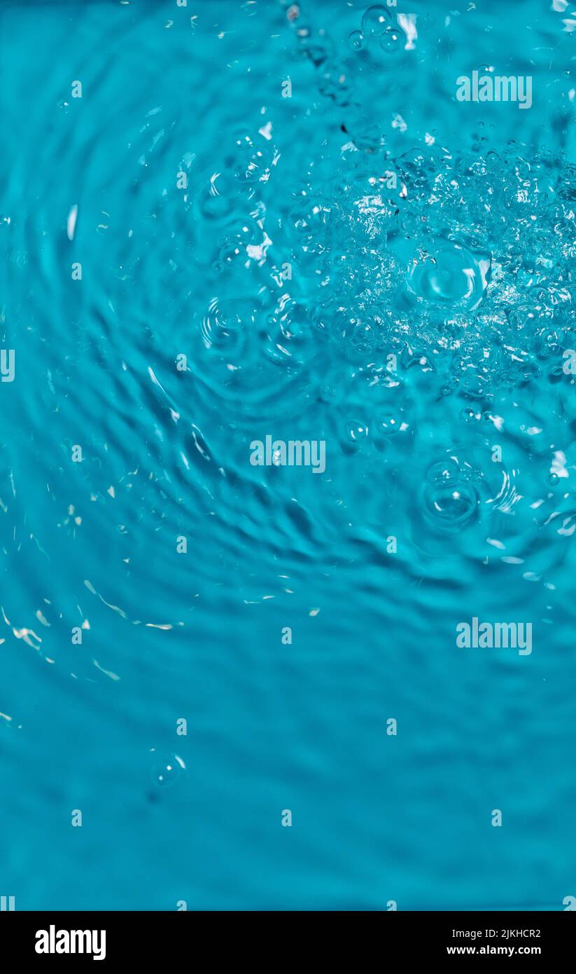 A beautiful shot of the clear and clean water of a pool with bubbles ...
