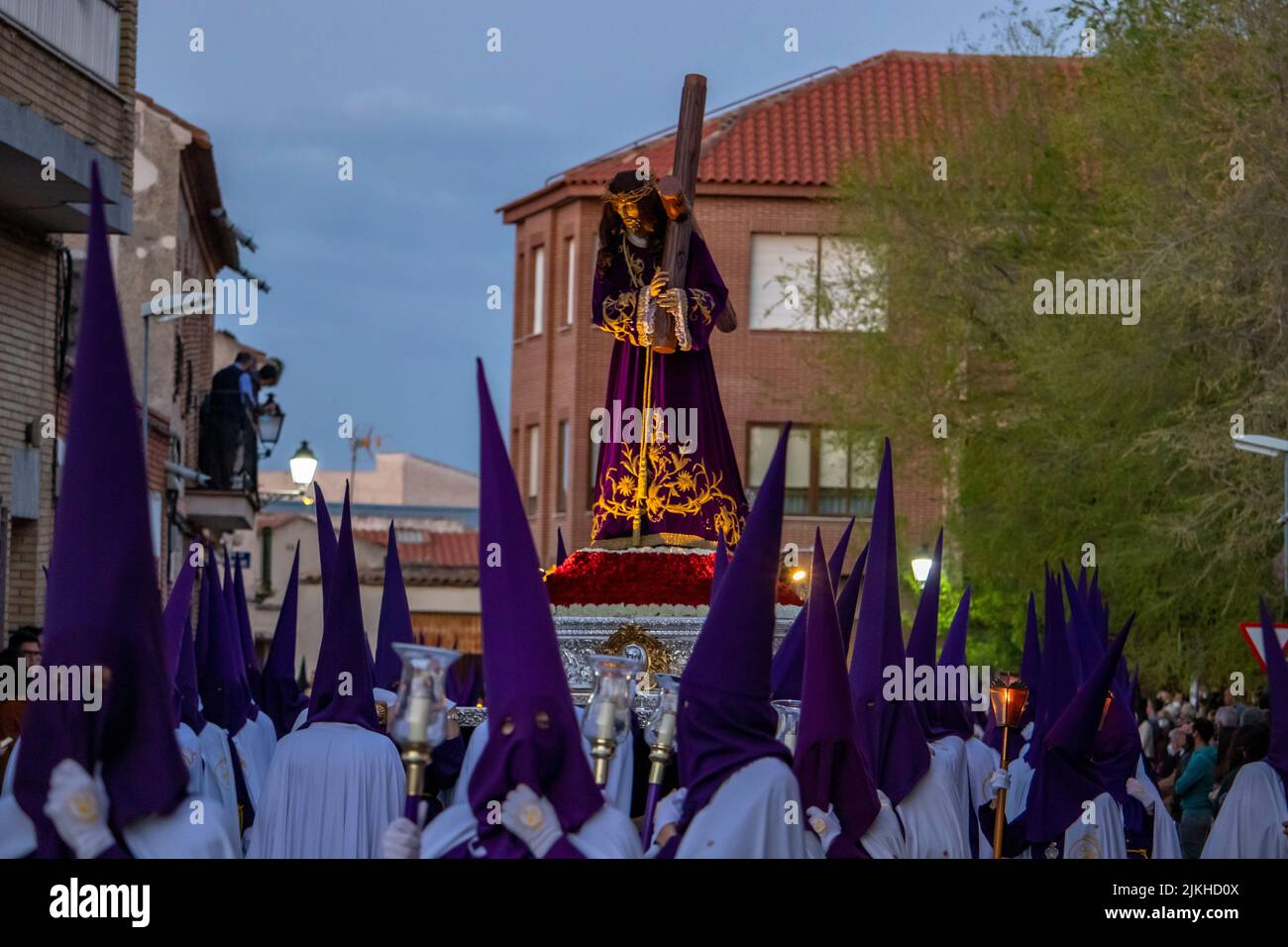 A group of people wearing uniforms and bearing the statue of Jesus ...