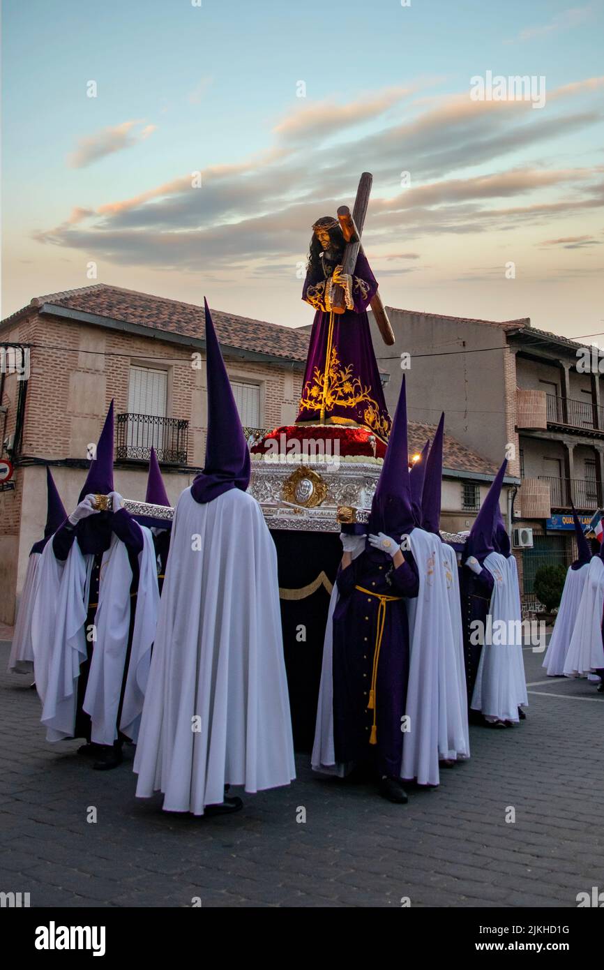 A group of people wearing uniforms and bearing the statue of Jesus ...