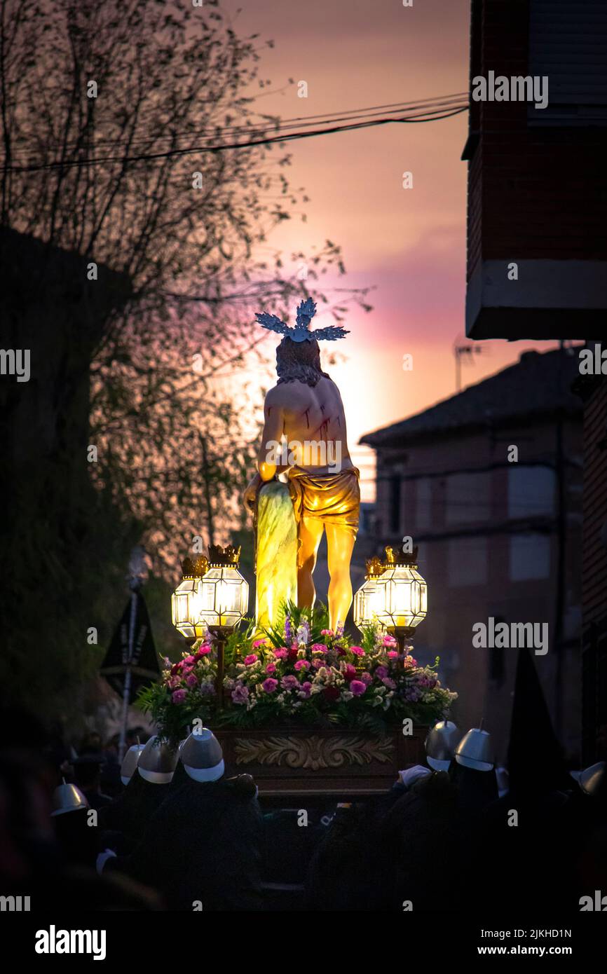 A group of people wearing uniforms and bearing the statue of Jesus ...