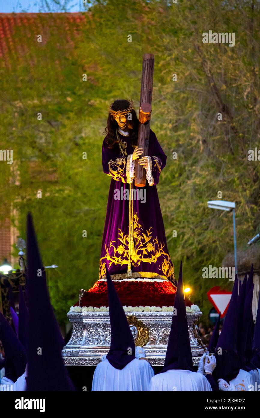 A group of people wearing uniforms and bearing the statue of Jesus ...
