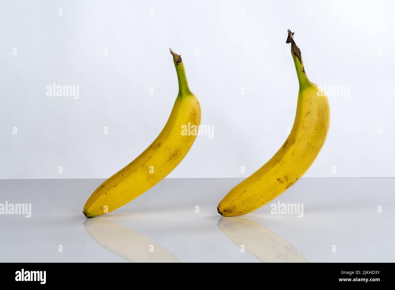 Two floating bananas on a white background Stock Photo - Alamy