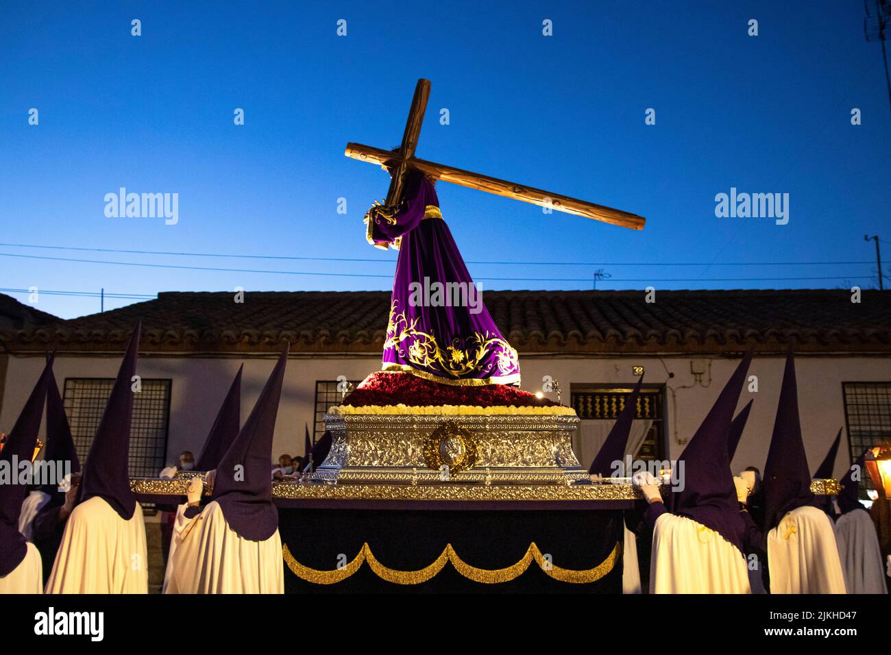 A group of people wearing uniforms and bearing the statue of Jesus ...
