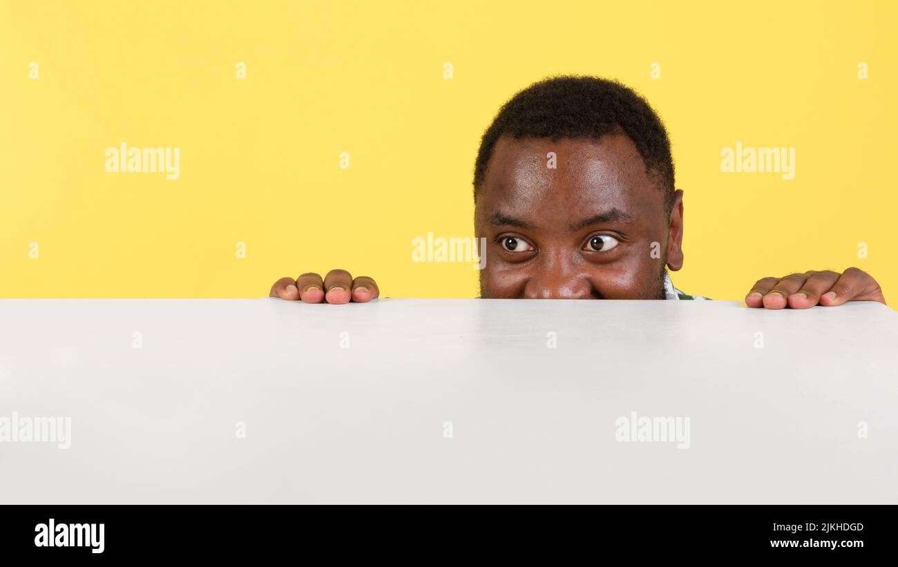 Hungry African American Man Looking At Empty Table, Yellow Background ...