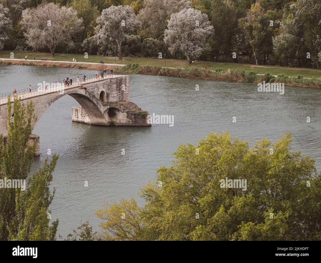 A high angle shot of people walking on the bridge of Avignon, France ...