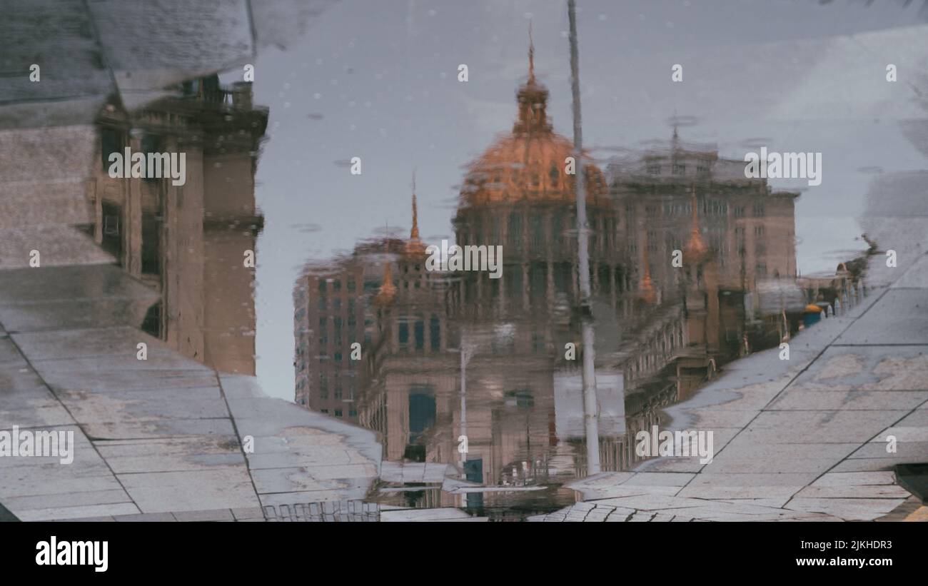 An upside down of a church reflecting in a puddle in Harbin, China ...