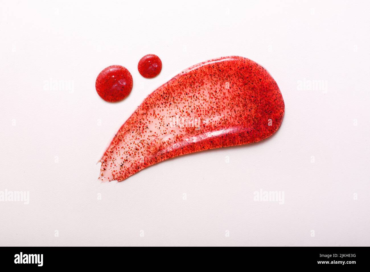 A red Creamy drop skincare cream product lotion on white background ...