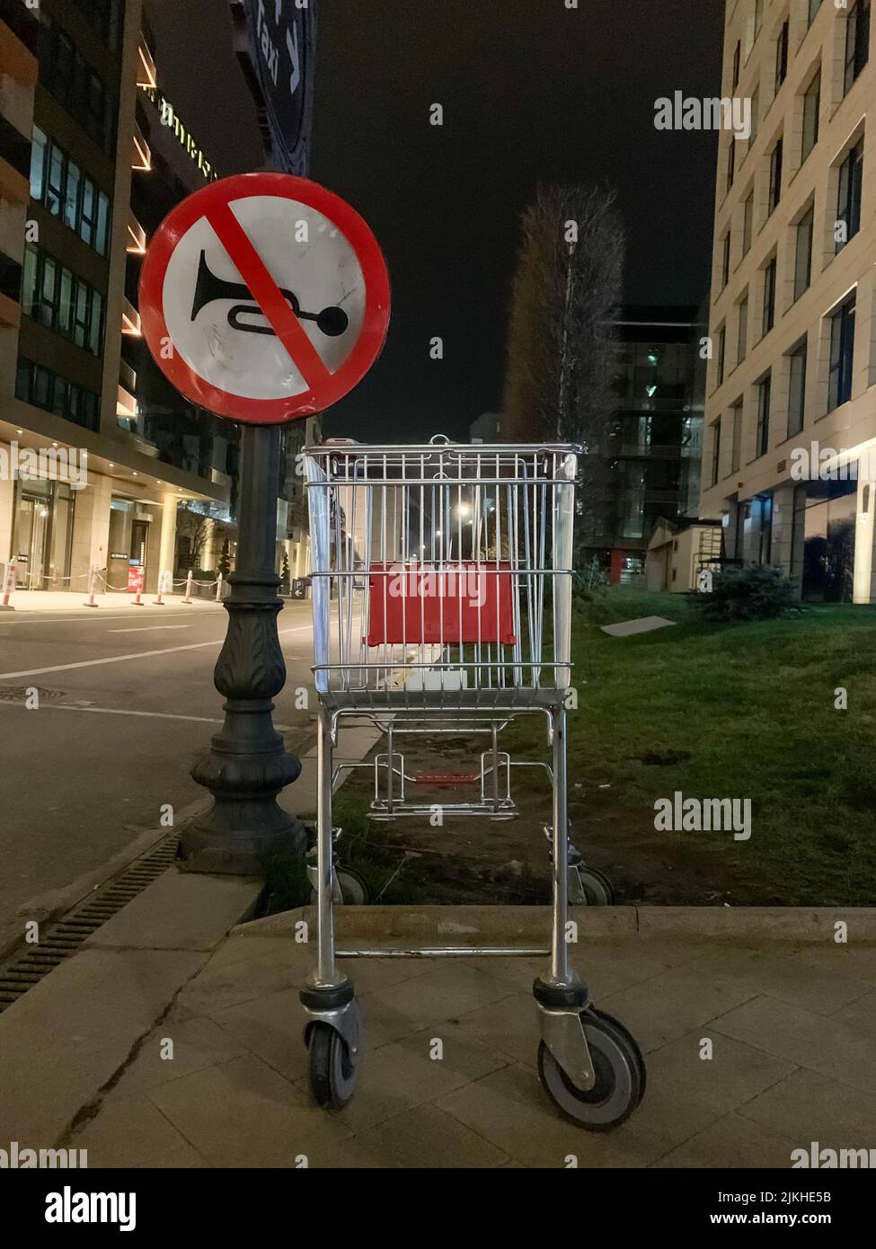 A verical shot of empty shopping cart in front of beeping prohibited ...