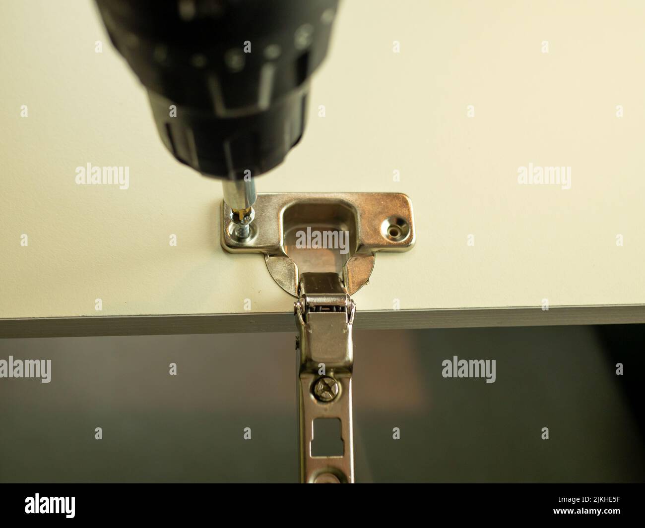 The master attaches accessories to furniture details. Assembly of ...