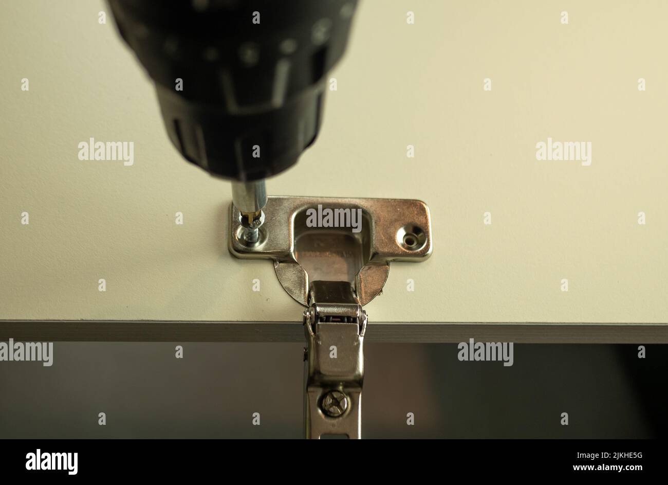 The master attaches accessories to furniture details. Assembly of ...