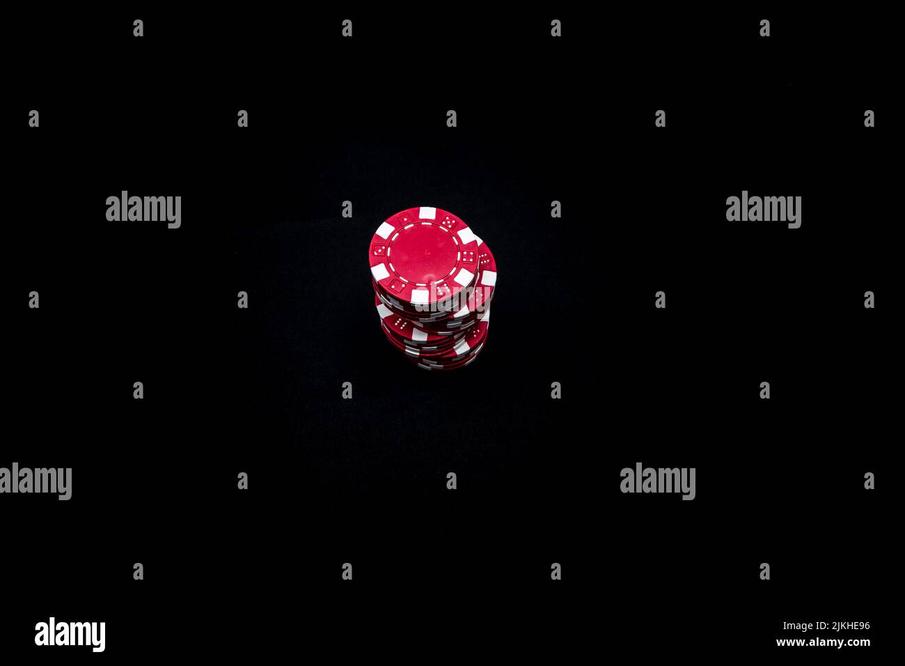 Stack of poker chips on black background Stock Photo - Alamy