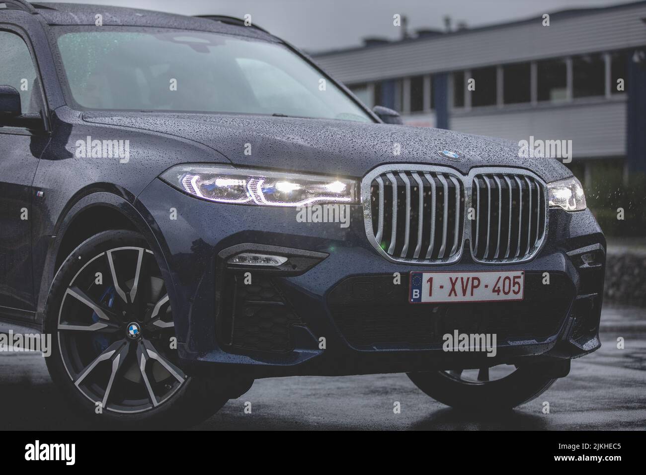 A luxury blue BMW X7 parked on the road on a cold rainy day Stock Photo ...