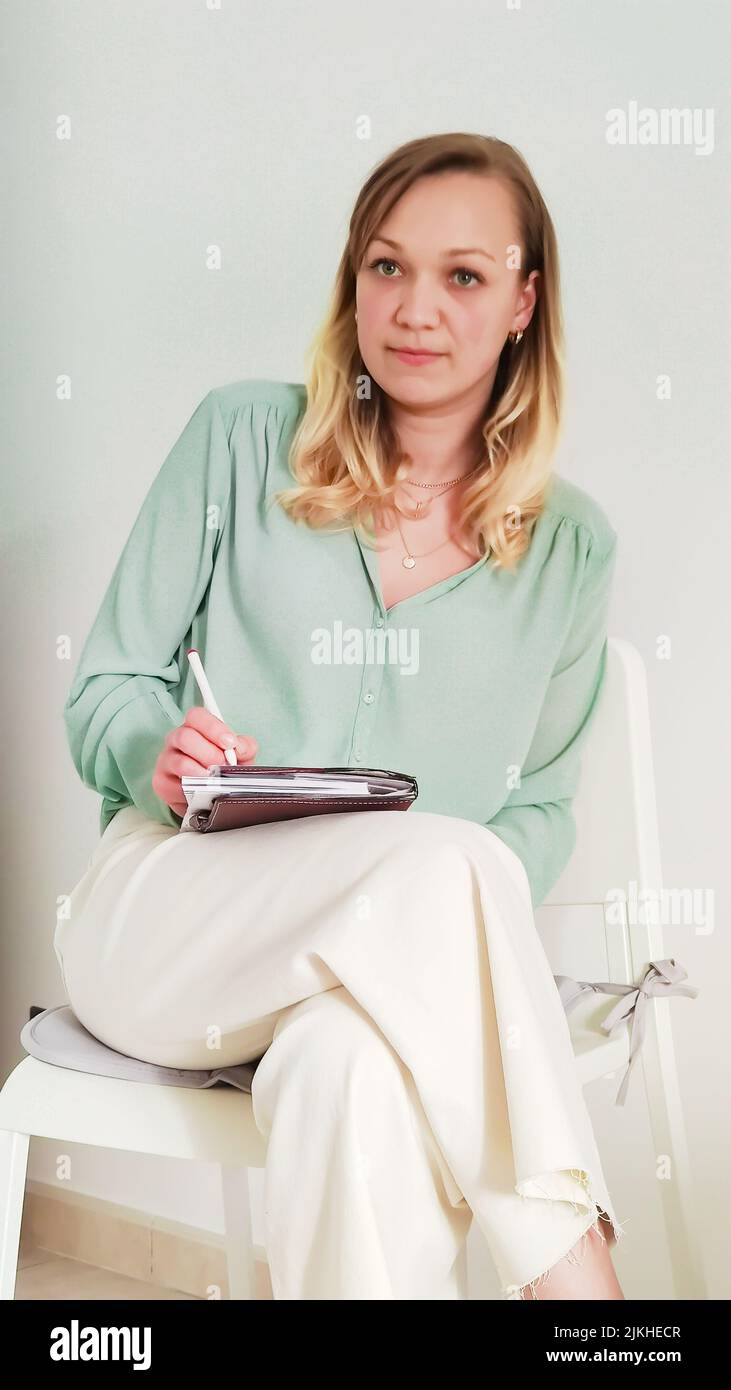 the secretary sits on a chair and asks for notes Stock Photo - Alamy