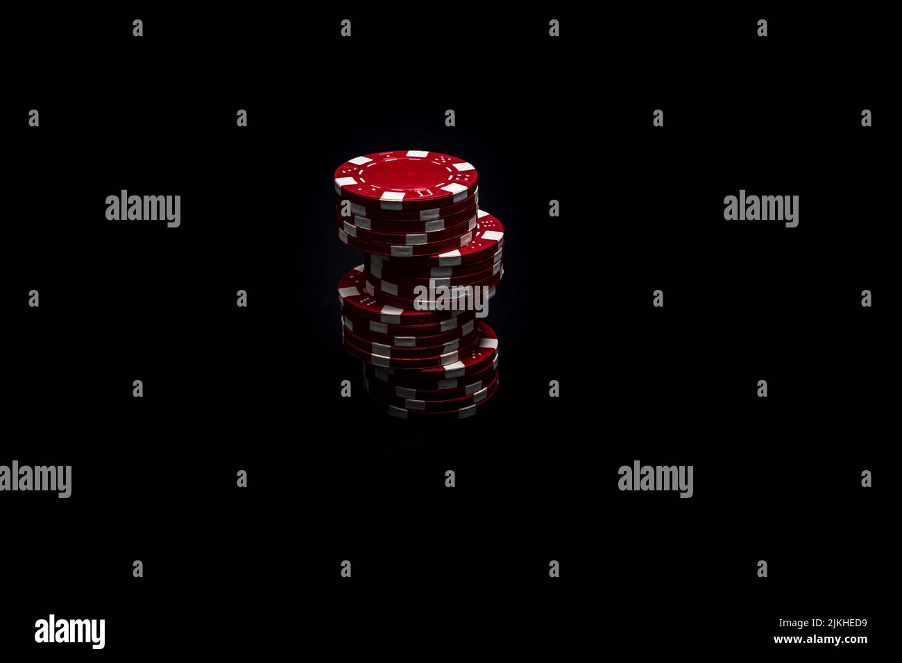 Stack of poker chips on black background Stock Photo - Alamy
