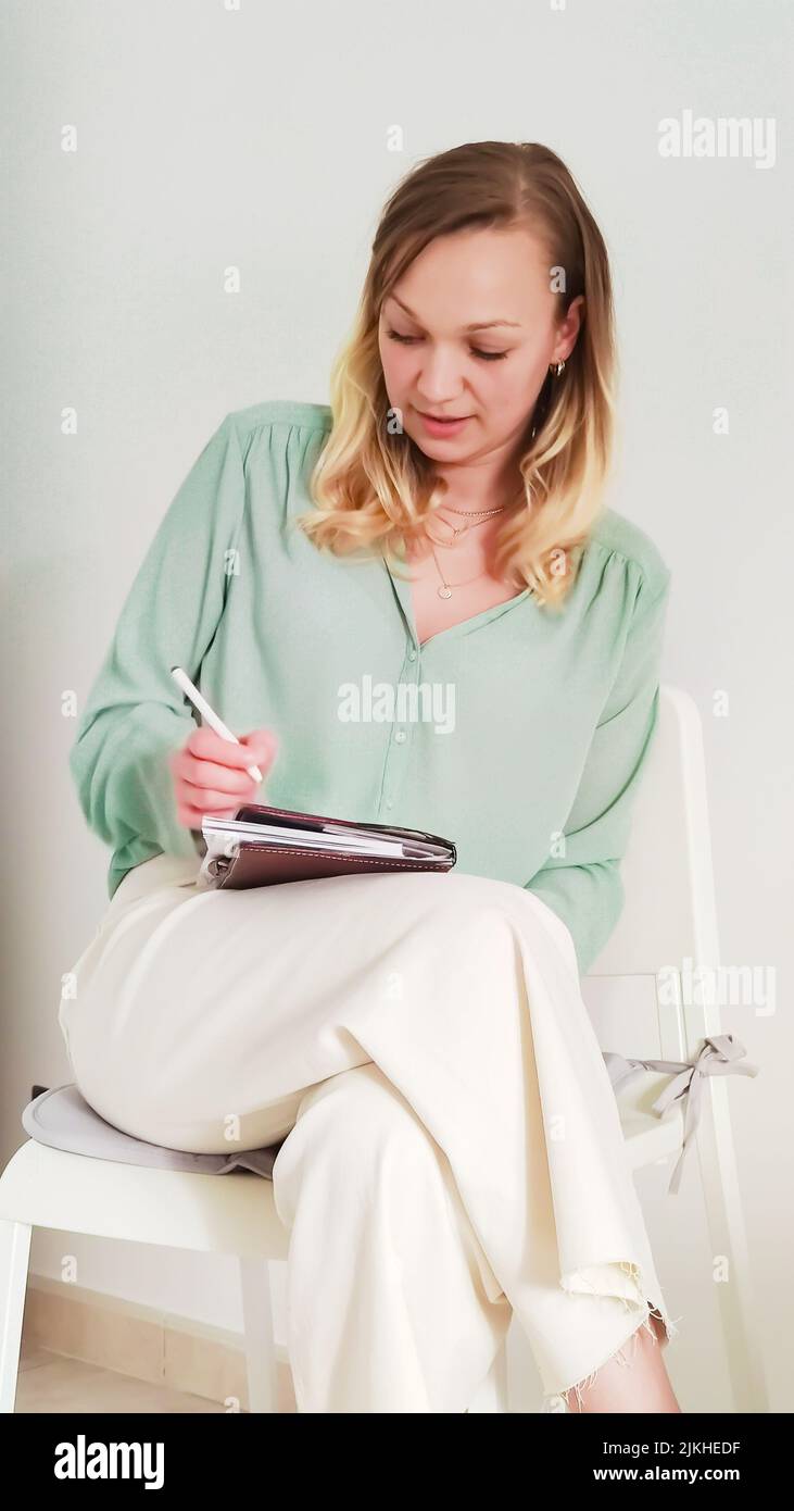 the secretary sits on a chair and asks for notes Stock Photo - Alamy