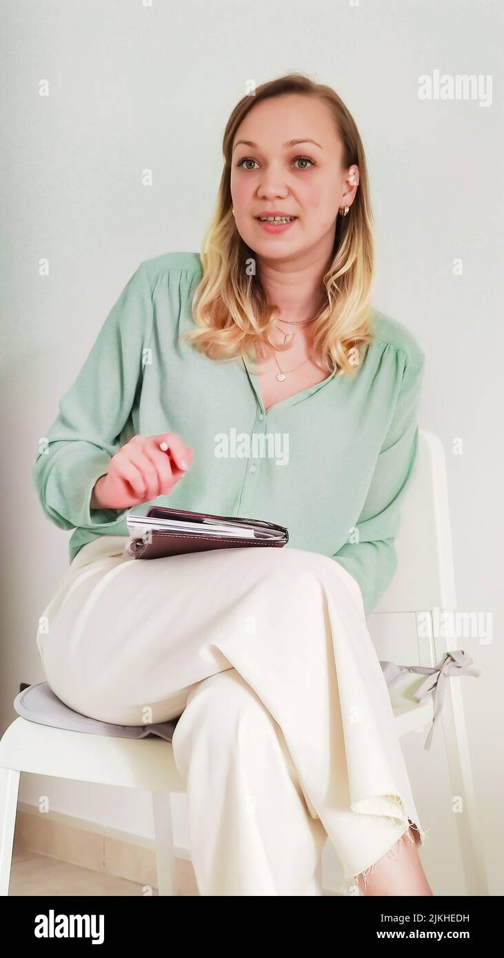 the secretary sits on a chair and asks for notes Stock Photo - Alamy