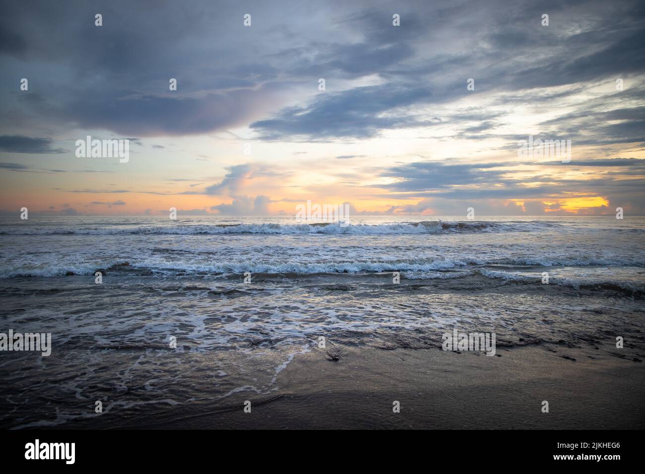 A calming sunset view over the waves of the sea Stock Photo - Alamy