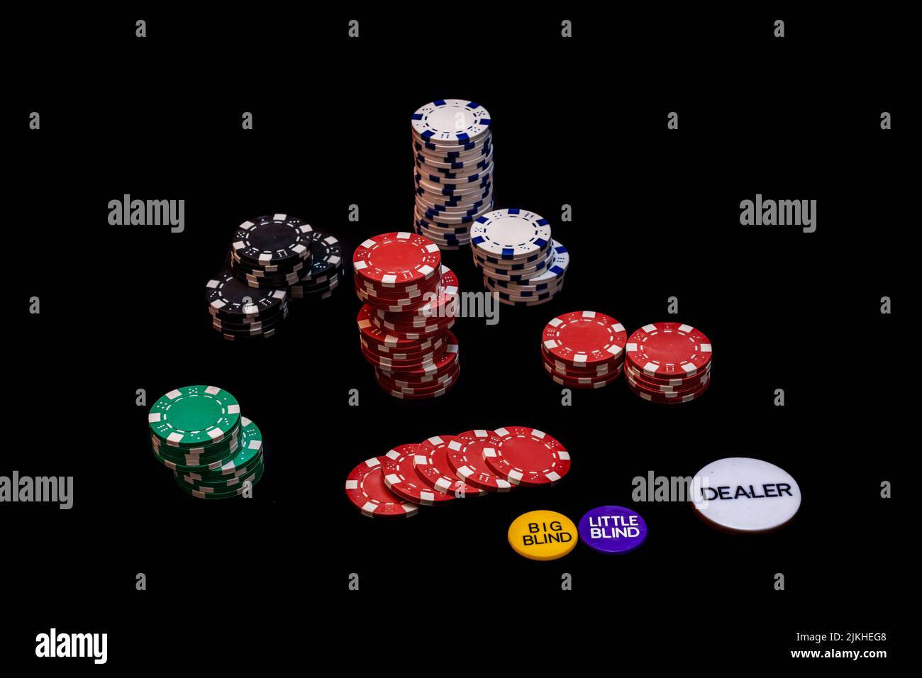 A number of stacks of colorful poker chips in a dark background Stock ...