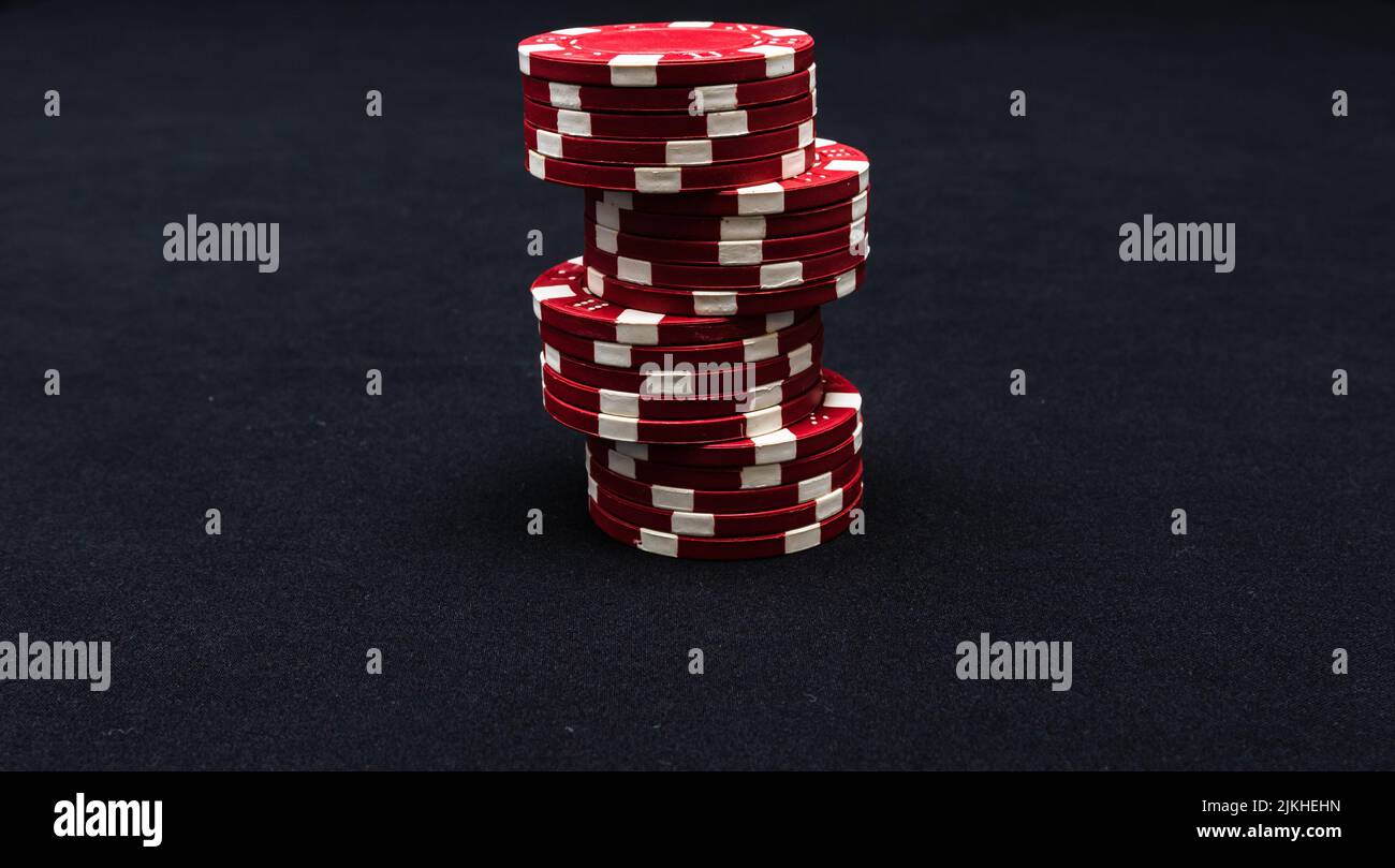 Stack of poker chips on black background Stock Photo - Alamy