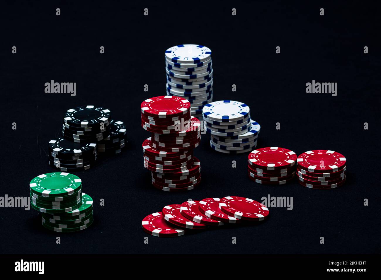 Stack of poker chips on black background Stock Photo - Alamy