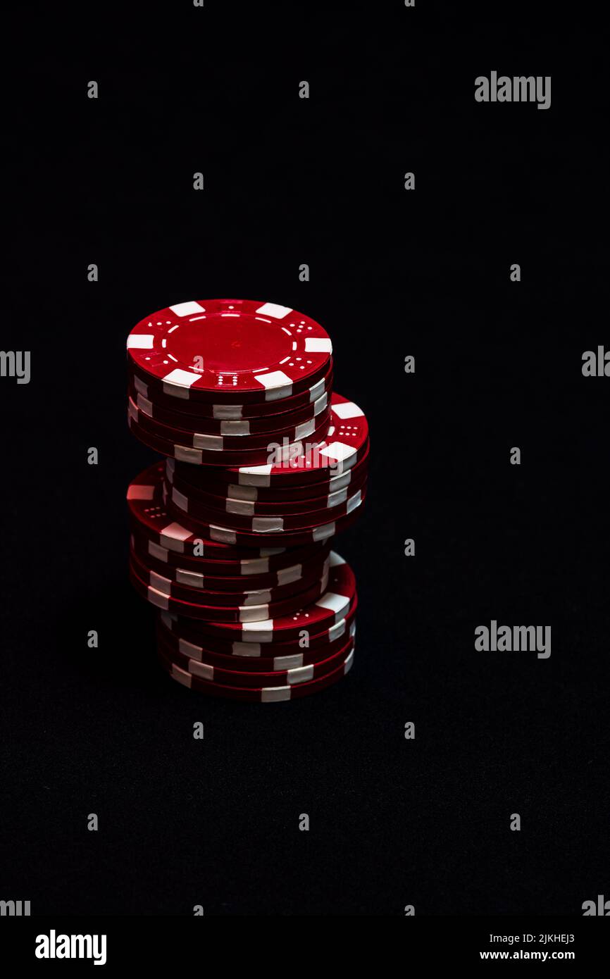 Stack of poker chips on black background Stock Photo - Alamy