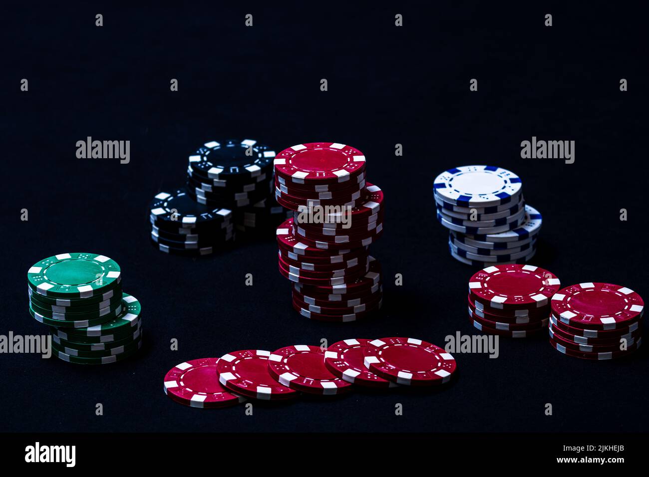 Stack of poker chips on black background Stock Photo - Alamy