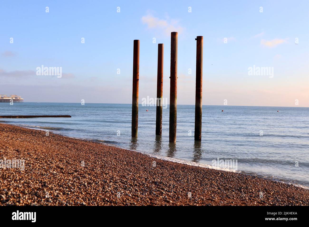 Four chimney poles standing on the beach at sunset in Brighton, England ...