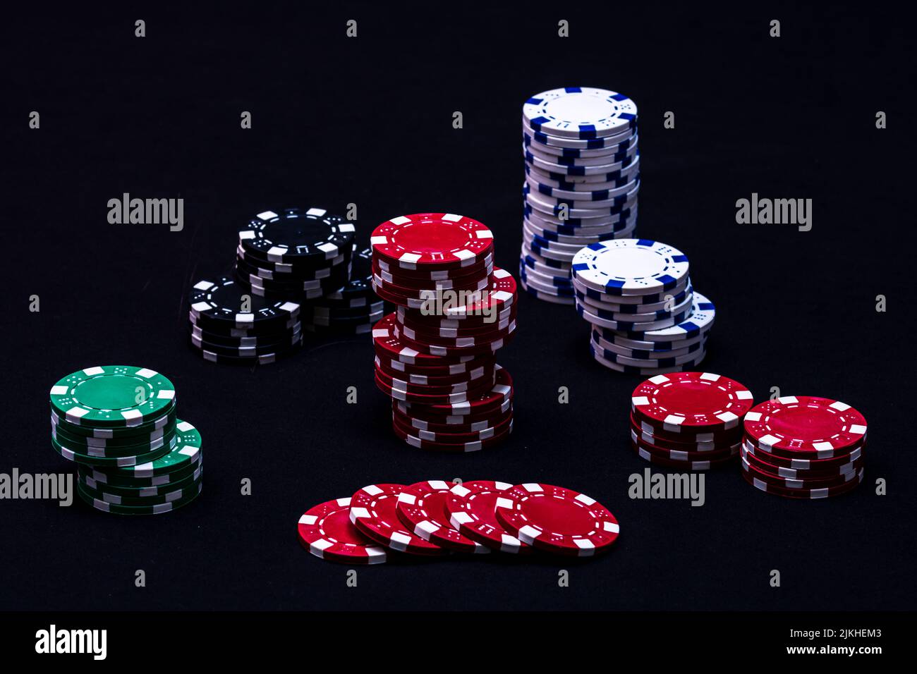 Stack of poker chips on black background Stock Photo - Alamy