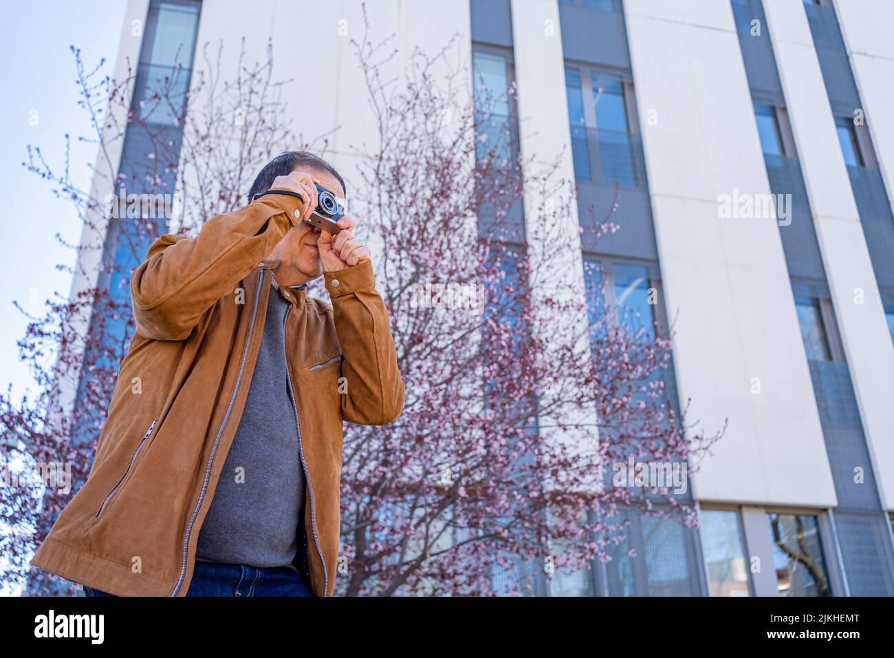 Older man photographing in the city with his old film camera Stock ...