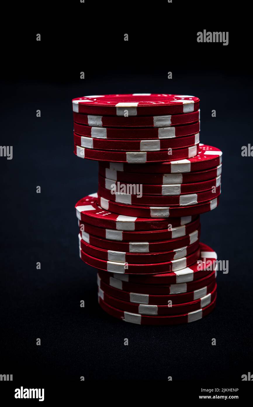 Stack of poker chips on black background Stock Photo - Alamy