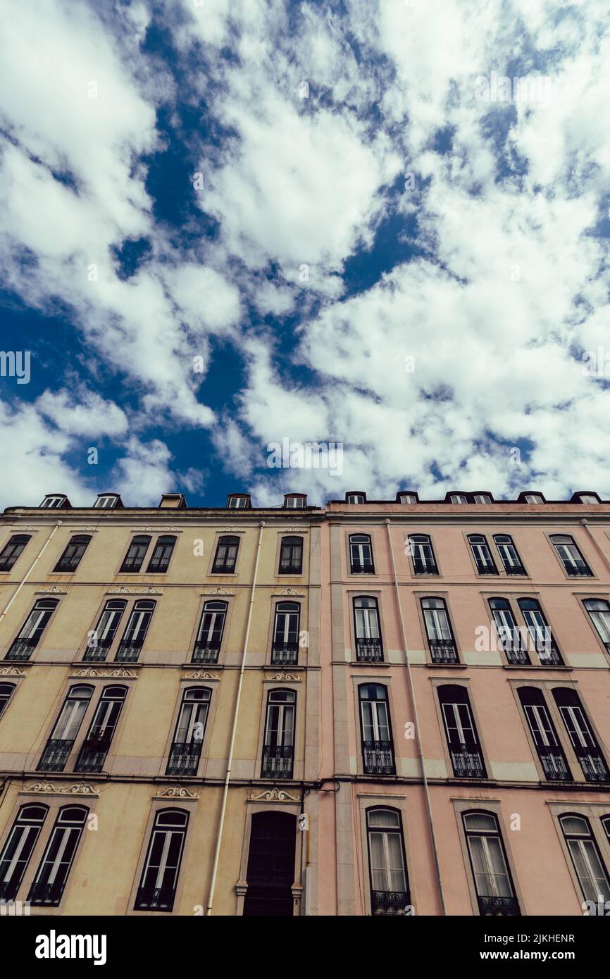 The low-angle shot of the buildings facade and cloudy skyline, Lisbon ...