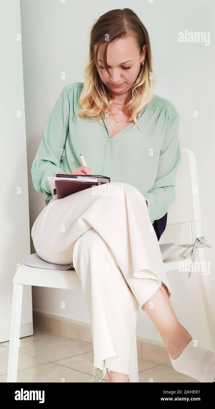 the secretary sits on a chair and asks for notes Stock Photo - Alamy