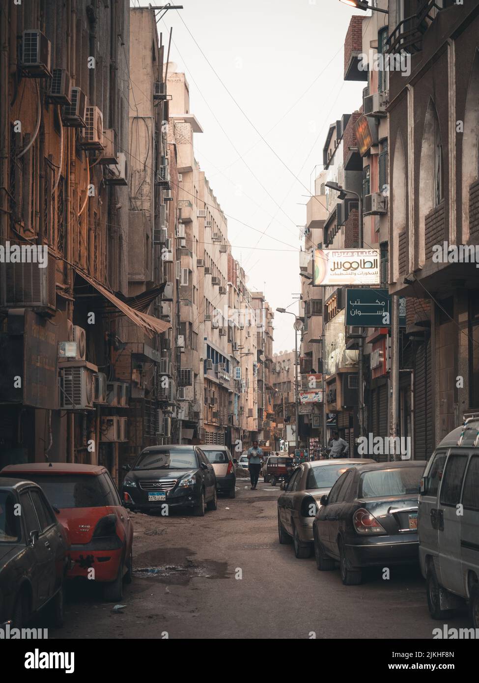 A beautiful view of a street with parked cars and buildings in Aswan ...