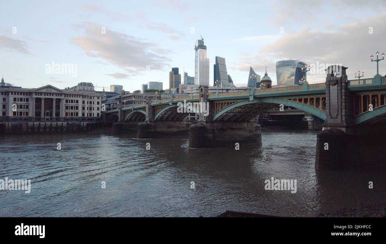 A beautiful sunset at river Thames with buildings in the city center of ...