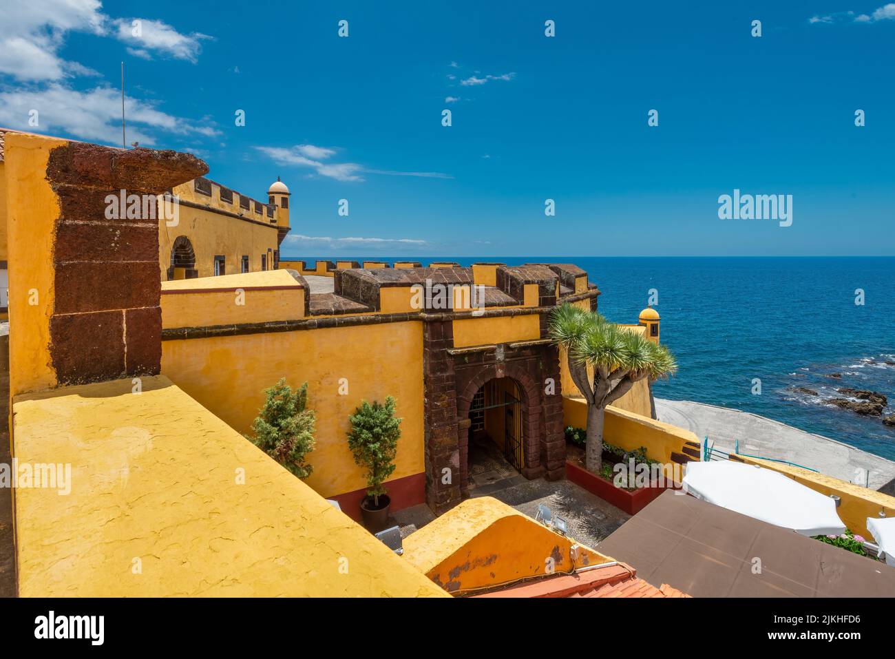 The Yellow castle of Sao Tiago with the blue sea and cloudy sky in ...