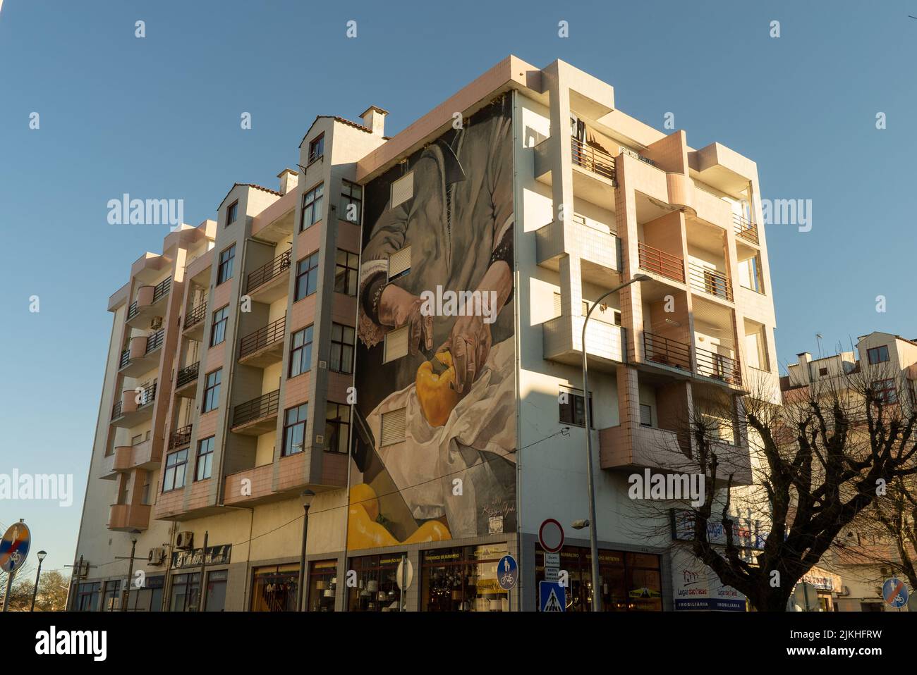 A low-angle shot of high rise city building with graffiti on facade ...
