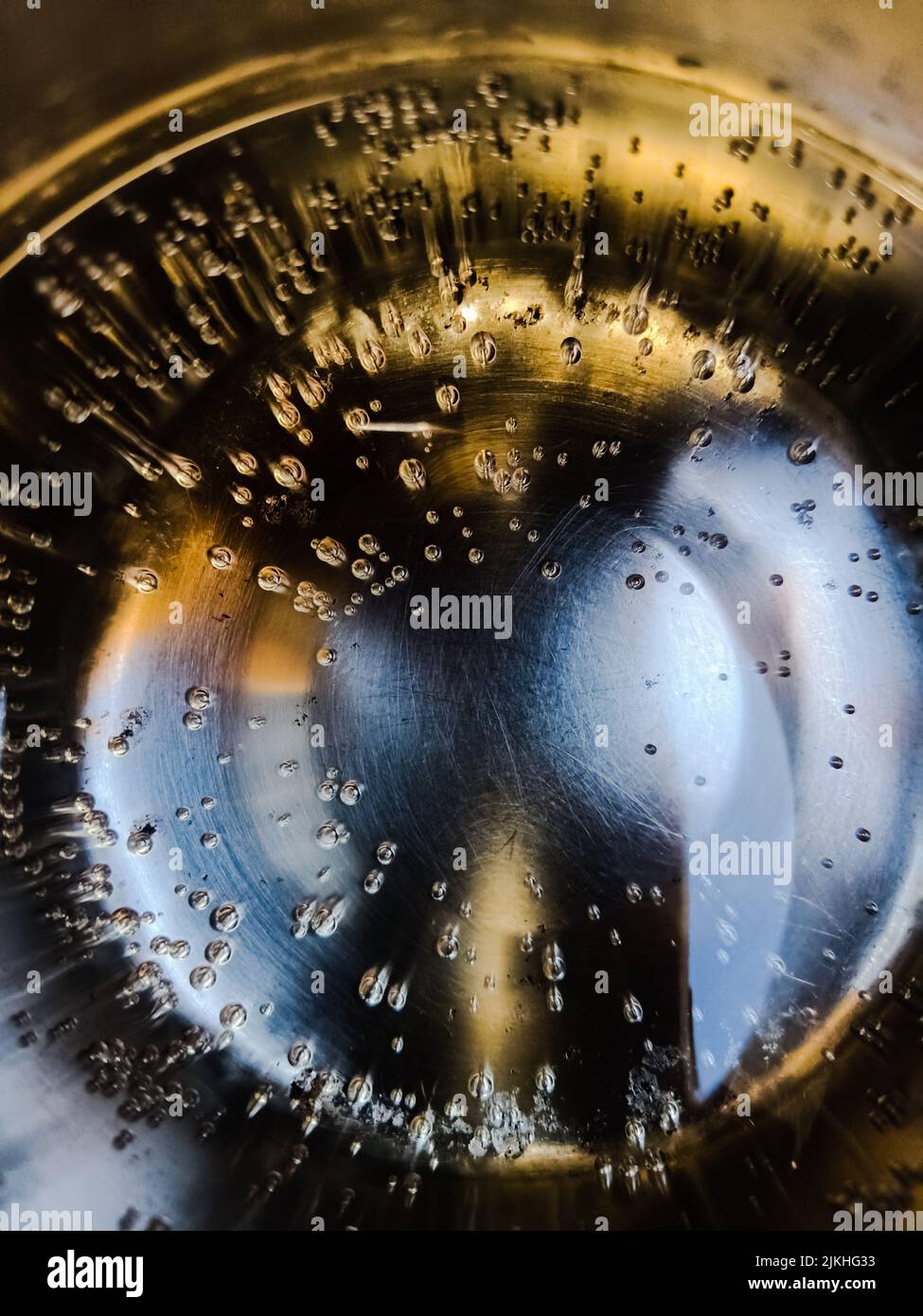 A vertical closeup shot of boiling water in the pan Stock Photo - Alamy