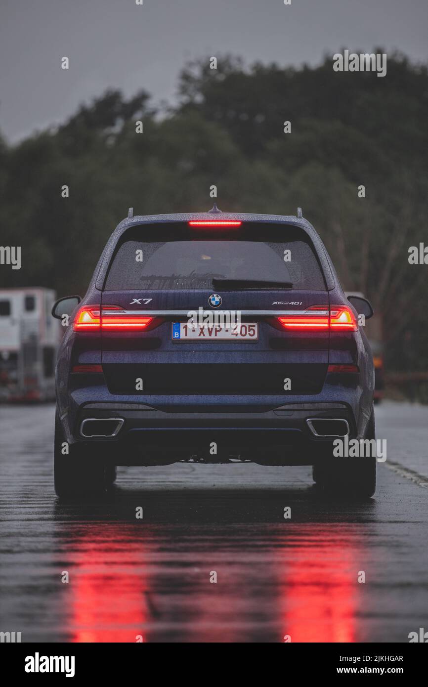 A vertical shot of rear of BMW X7 car in a rainy day Stock Photo - Alamy